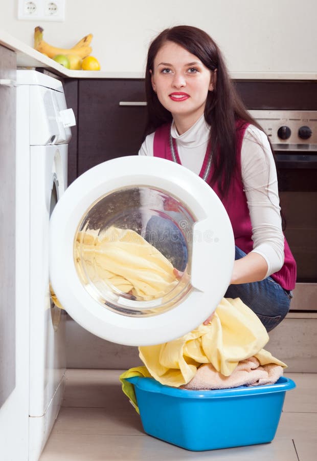Woman Loading Clothes into the Washing Machine Stock Photo - Image of ...