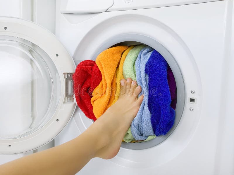Woman Loading Colorful Laundry in the Washing Machine Stock Photo ...