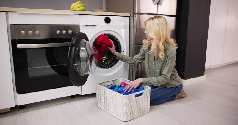 Woman Loading Dirty Clothes in Washing Machine for Washing Stock Photo ...