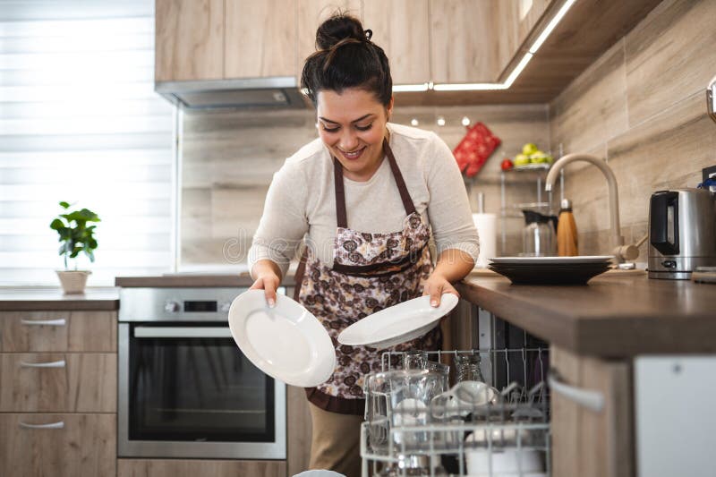 Woman Loading the Dishwasher in the Kitchen Stock Image - Image of ...