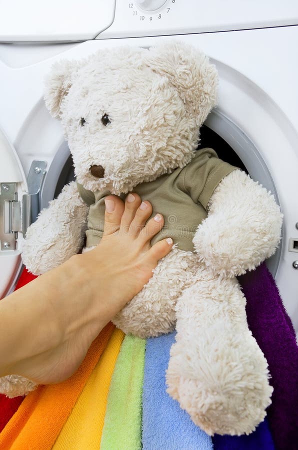 Woman Loading Fluffy Toy in the Washing Machine Stock Photo - Image of ...
