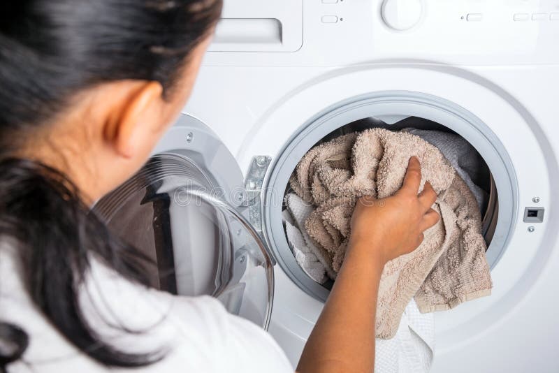 Woman loading laundry stock image. Image of chrome, appliance - 31689763