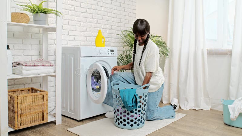 Woman Loading Laundry into Washing Machine in Bathroom Stock Video ...