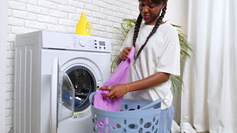 Woman Loading Laundry into Washing Machine in Bathroom Stock Video ...
