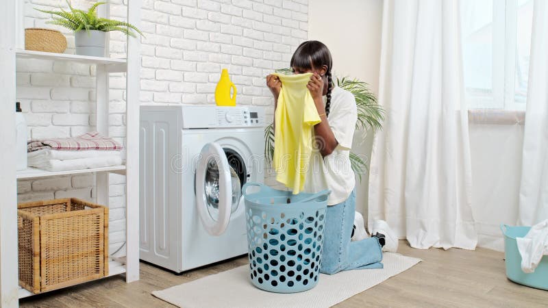Woman Loading Laundry into Washing Machine in Modern Home Stock Footage ...