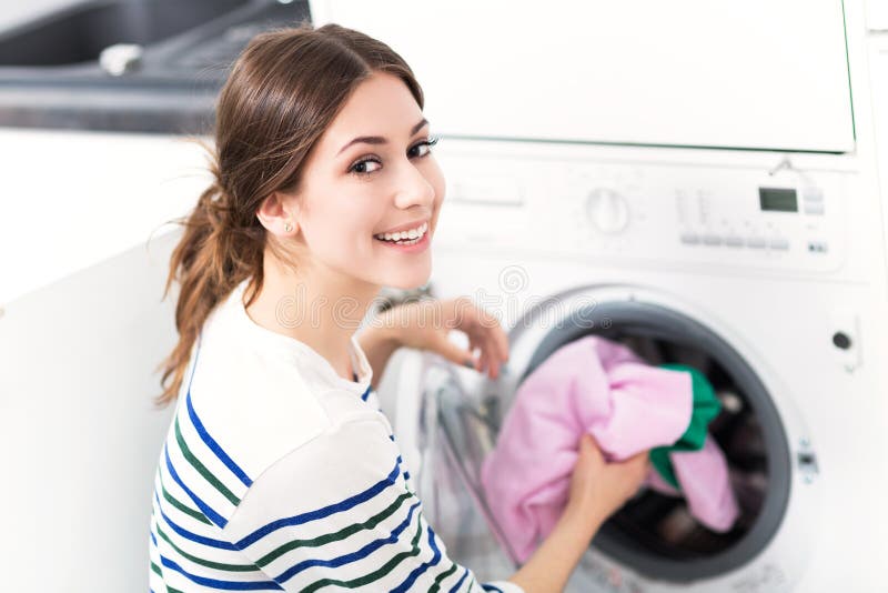 Woman Loading Washing Machine Stock Image - Image of young, wife: 55853285