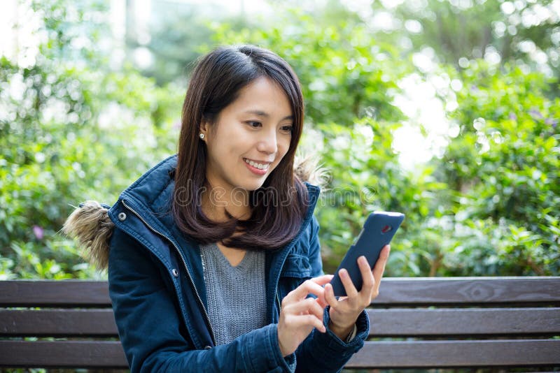 Woman look at mobile phone stock photo. Image of cellphone - 66309174