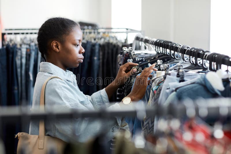 Woman Looking at Clothes on Rack Stock Photo - Image of sustainability ...
