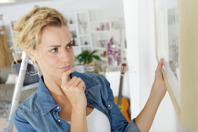 Woman looking at frame stock photo. Image of fashion - 332668588