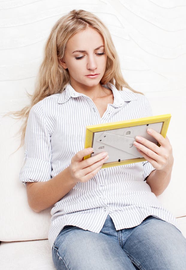 Woman Looking at a Frame with Photos Stock Photo - Image of grief ...