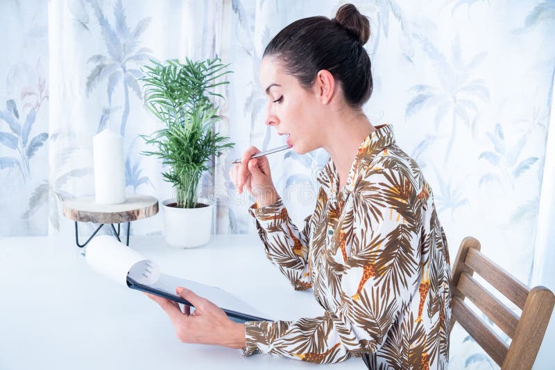 Woman Looking at Important Documents and Making a Checklist Stock Image ...