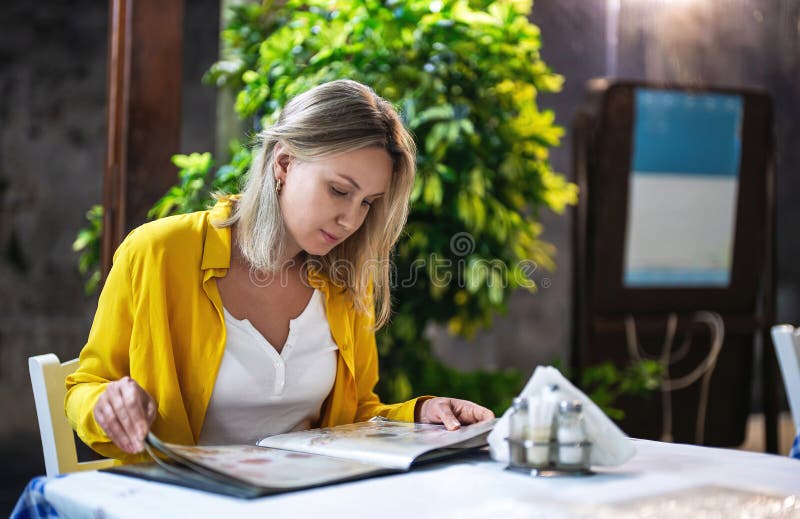 Woman is looking at menu stock photo. Image of client - 318385450