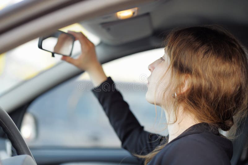 Woman Looking In The Mirror In A Car Stock Image - Image of adult ...