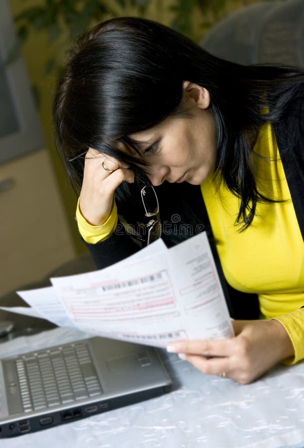 Woman Looking Over Paperwork Stock Image - Image of bills, papers: 7711989