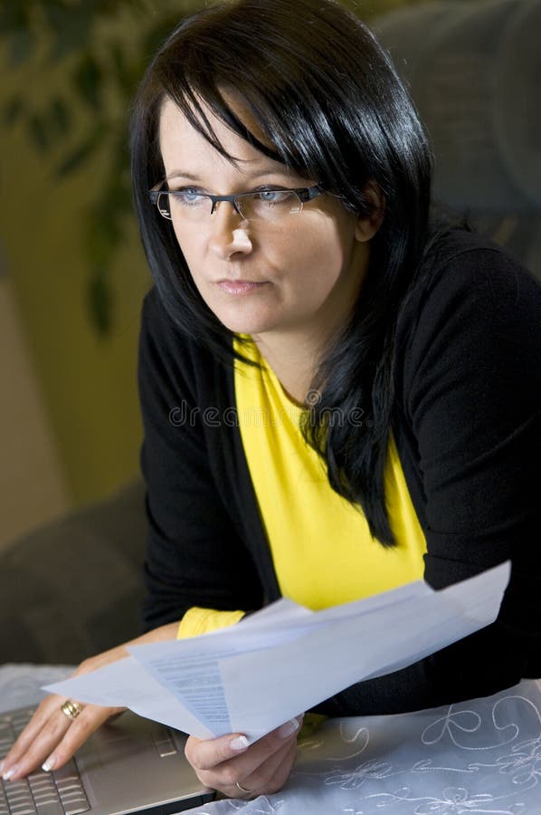Woman Looking Over Paperwork Stock Image - Image of bills, papers: 7711989