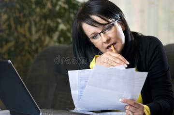 Woman Looking Over Paperwork Stock Image - Image of bills, papers: 7711989