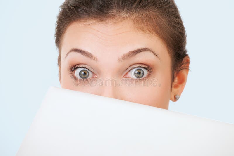 A Woman Looking Over the Top of a Laptop Computer. Stock Photo - Image ...