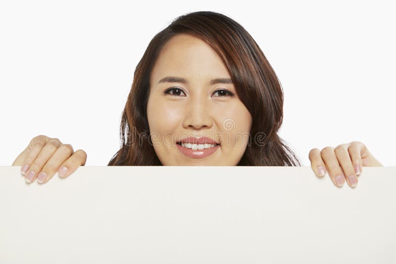 Woman looking over a wall stock image. Image of person - 186230401