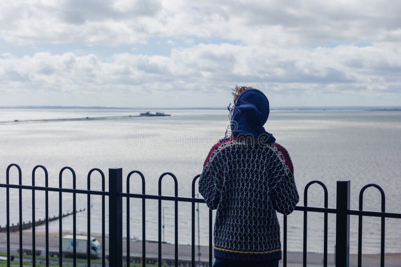 Woman Looking at a Pier by the Seaside Stock Photo - Image of boardwalk ...