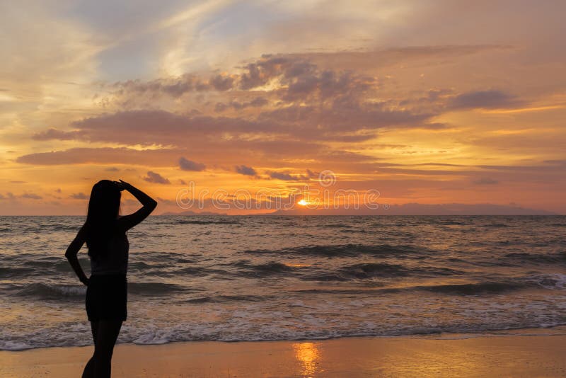 Woman Looking in the Sunset Stock Image - Image of beach, serenity ...