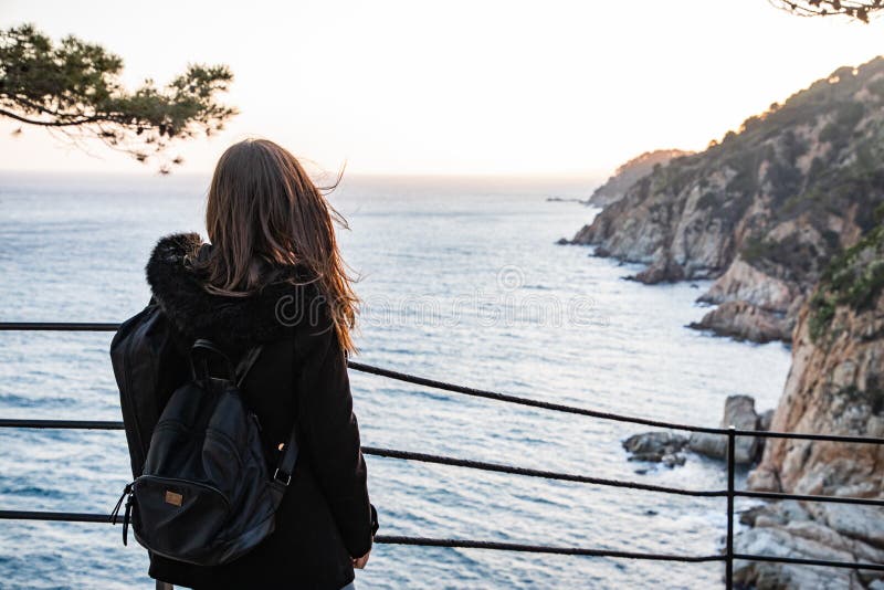 Woman Looking at Sunset on Rocky Cliff Coastline Stock Image - Image of ...