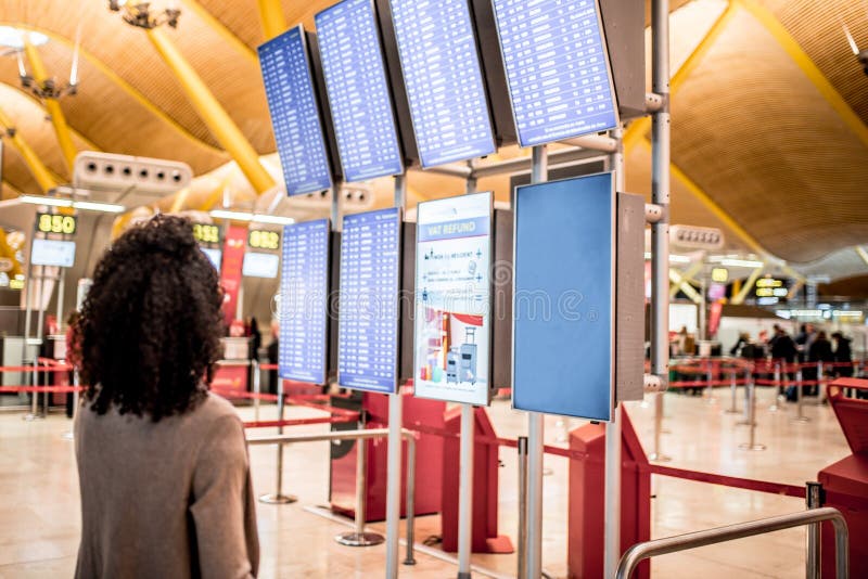 Woman Looking at the Timetable Information Panel in the Airport Stock ...