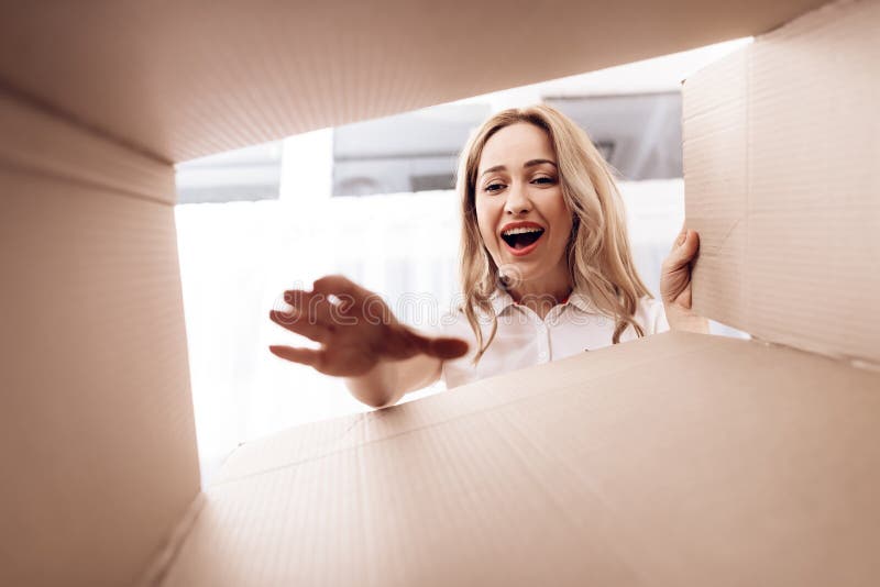 A Woman Looks into the Empty Box from the Inside. Close-up Photo of a ...