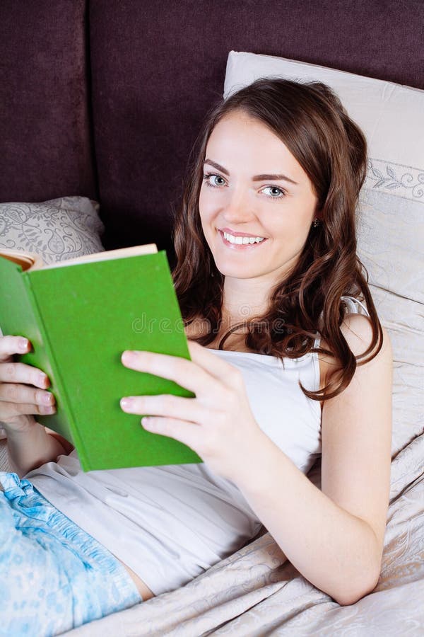 Woman Lying In Bed While Reading A Book Stock Image Image Of House