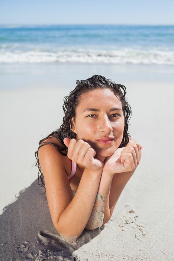 Woman lying down at beach stock photo. Image of bikini - 33386872