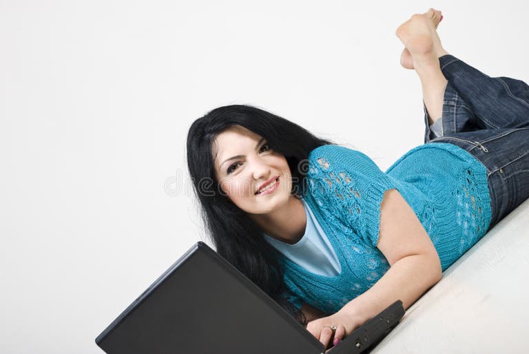 Woman Lying Down and Using Laptop Stock Image - Image of laptop, jeans ...