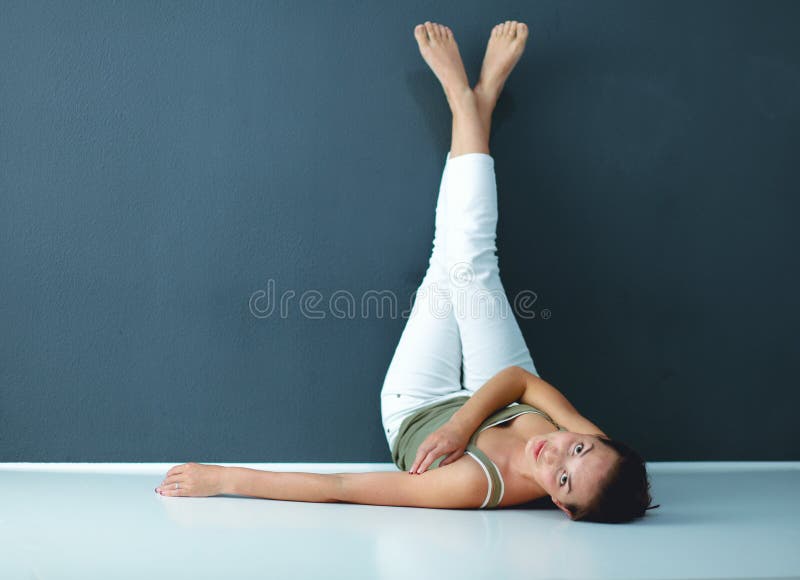 A Woman Lying on the Floor with Legs Up Stock Photo - Image of cheerful ...