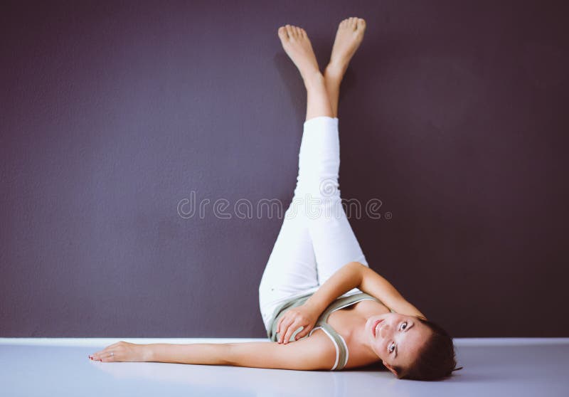 A Woman Lying on the Floor with Legs Up Stock Image - Image of modern ...