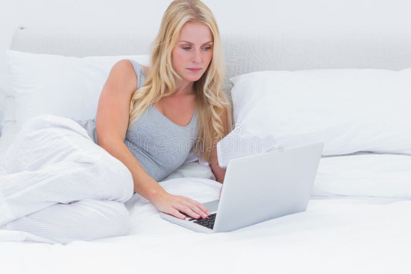 Woman Lying on Her Bed Using a Laptop Stock Image - Image of bedroom ...
