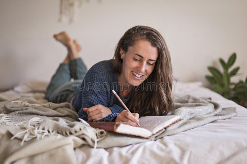 Woman Lying on Her Bed Writing in Her Journal Stock Image - Image of ...