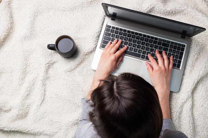 Woman Lying on a White Wool Blanket and Working at Computer Hands ...