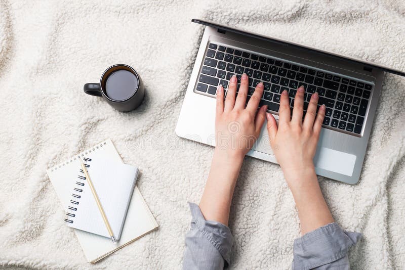 Woman Lying on a White Wool Blanket and Working at Computer Hands ...
