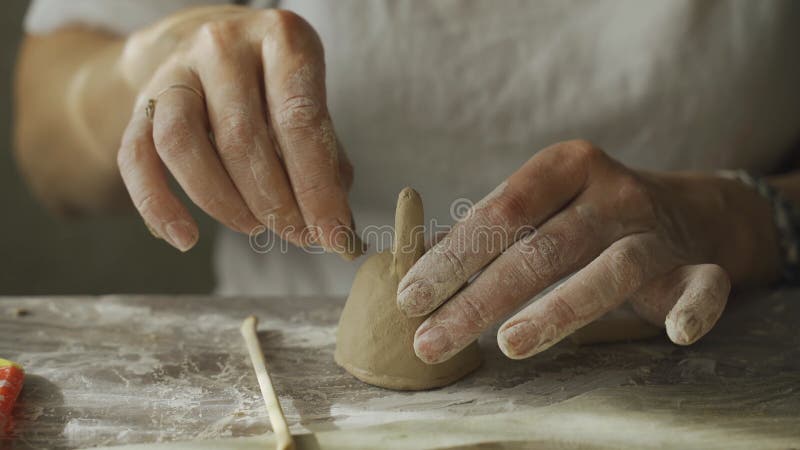 A Woman Makes a Ceramic Pot and Legs Using a Tool. Stock Footage ...