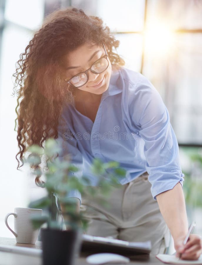 Woman Makes a Report in the Office. Woman Writing Notes for Educational ...