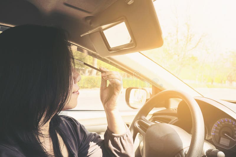 Woman Makeup Her Face Using Eyebrow Pencil while Driving Car Stock ...