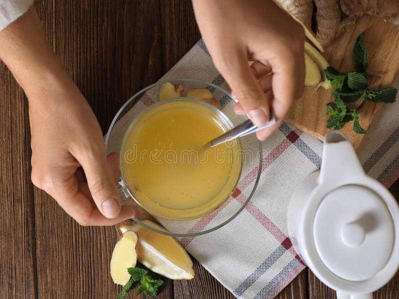 Woman Making Aromatic Ginger Tea at Wooden Table, Top View Stock Photo ...
