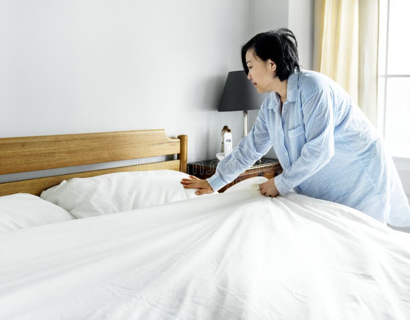 A woman making the bed stock photo. Image of alone, making - 109175044