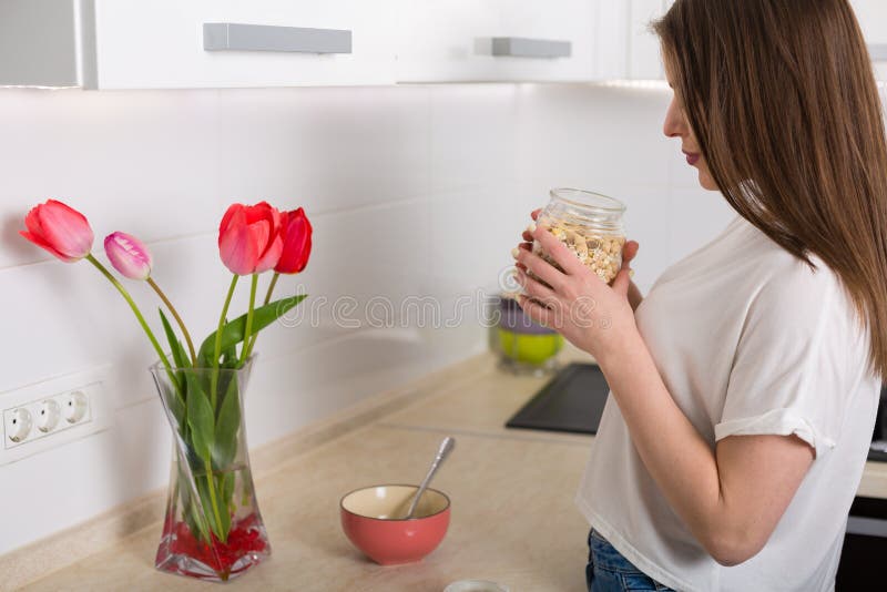 Woman making breakfast stock image. Image of cereal, flowers - 91029743
