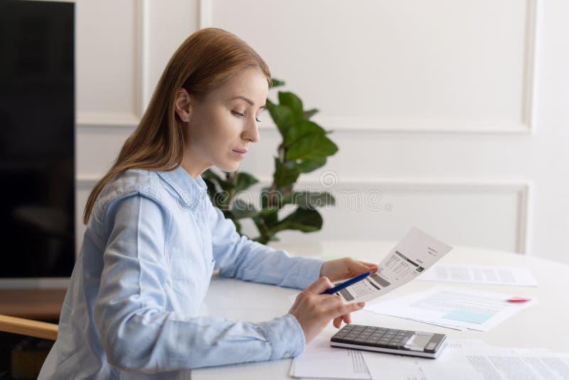 Woman Making Calculations and Looking at Documents Stock Image - Image ...