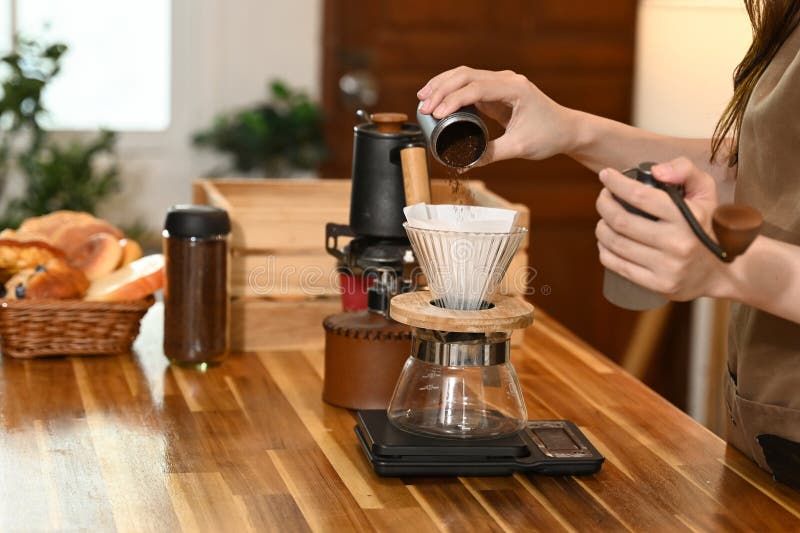 A Woman is Making Coffee Using a French Press. she is Pouring Coffee ...