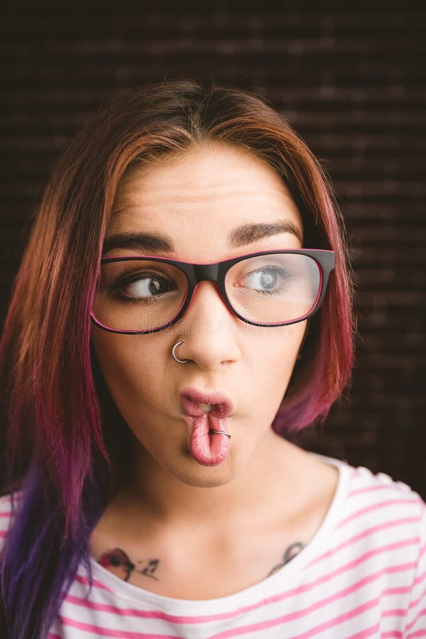 Woman Making Facial Expression Against Brick Wall Stock Photo - Image ...
