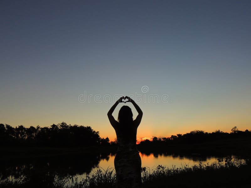 Woman Making Heart with Hands Over Head Stock Photo - Image of fazendo ...