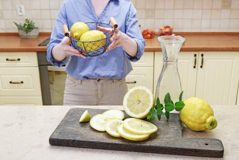 Woman Making Lemonade in Her Kitchen Stock Photo - Image of hand ...