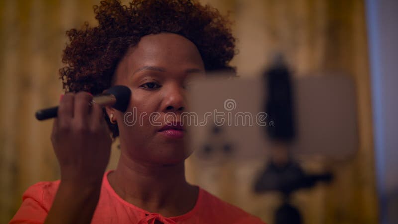 A Woman is Making a Makeup Tutorial by Filming Herself Using Her ...