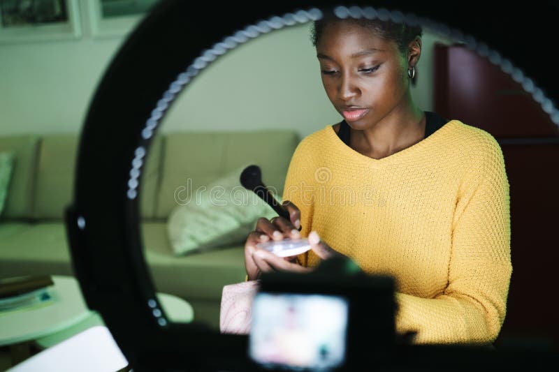 A Woman is Making a Makeup Tutorial, Using a Ring Light for Ideal ...
