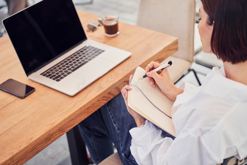 Woman Making Notes in Notebook Stock Image - Image of gadget, caffeine ...